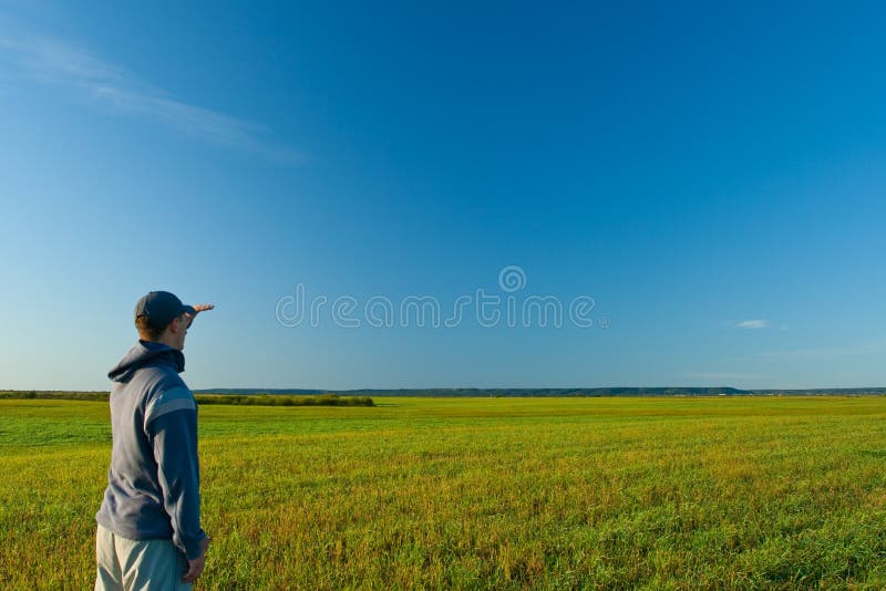Man looking far away stock image. Image of field, standing - 13384347