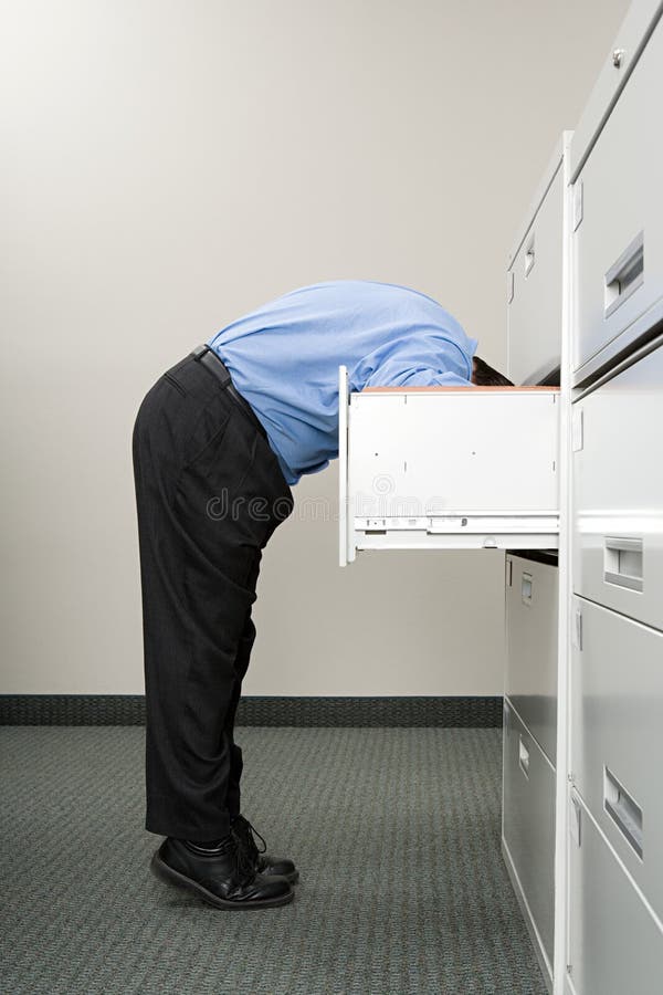 Man Looking in Filing Cabinet Stock Image - Image of looking, open ...