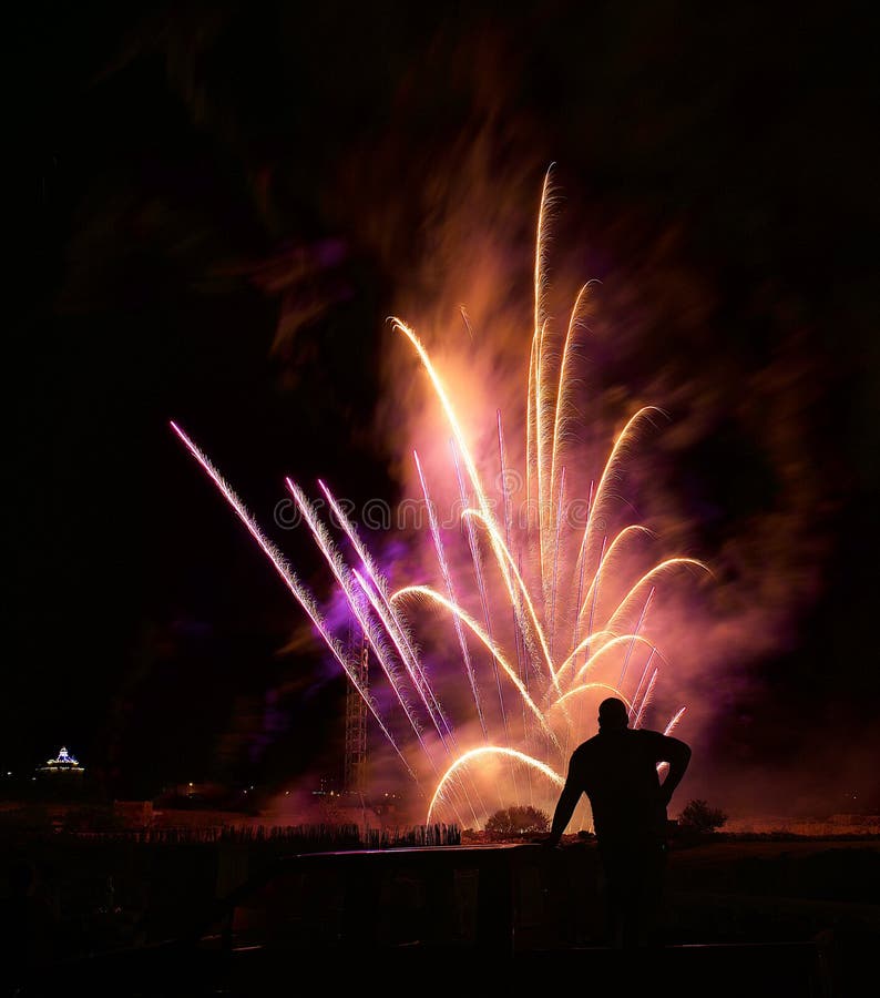 Man Looking Fireworks in New Year Evening. Nice Fireworks Explode Stock ...
