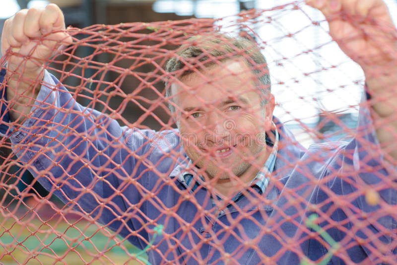 Man Looking through Fishing Netting Stock Photo - Image of check ...