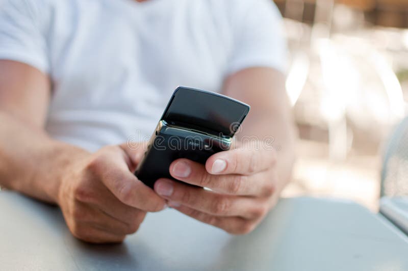 A Man Looking at His Cellphone Stock Photo - Image of patio, mobile ...