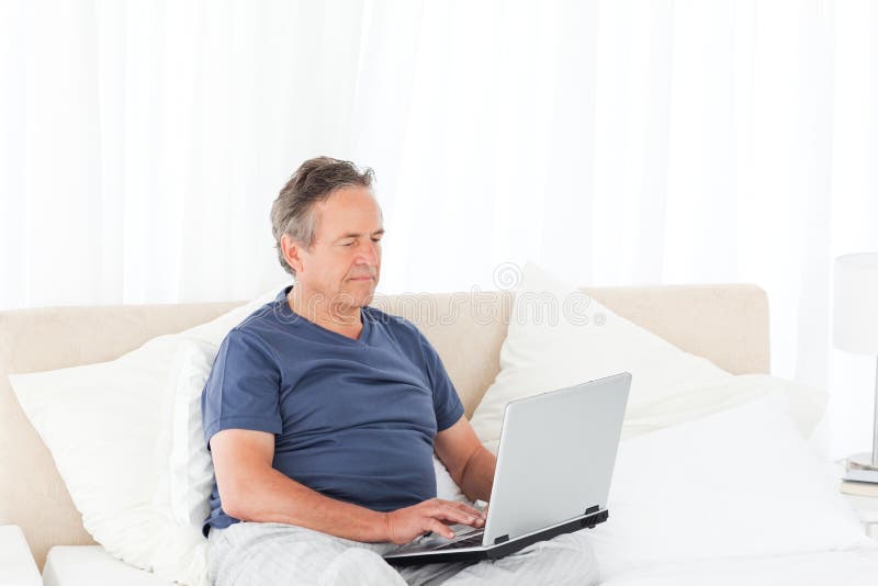 Man looking at his laptop stock image. Image of healthy - 18109481