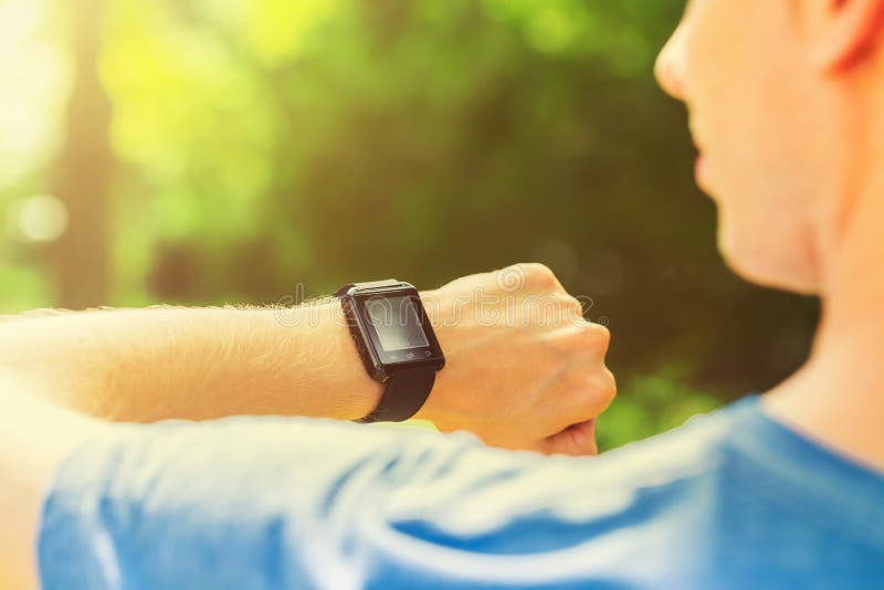 Man Looking at His Smart Watch Outside Stock Photo - Image of smart ...