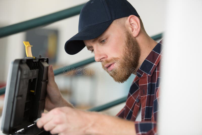 Man looking in tool box stock image. Image of craft - 263611975