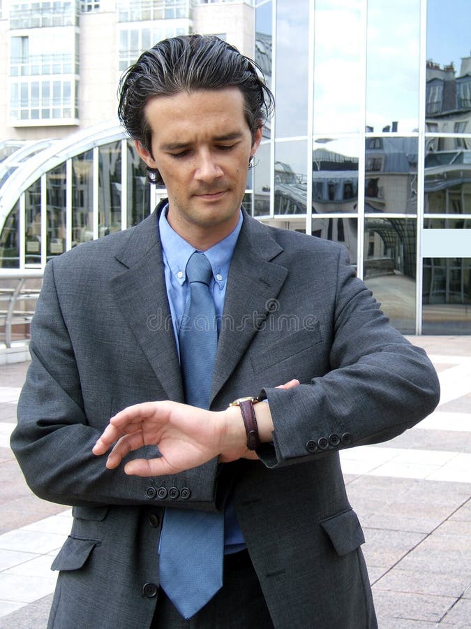 Man looking at his watch stock image. Image of businessmen - 209821