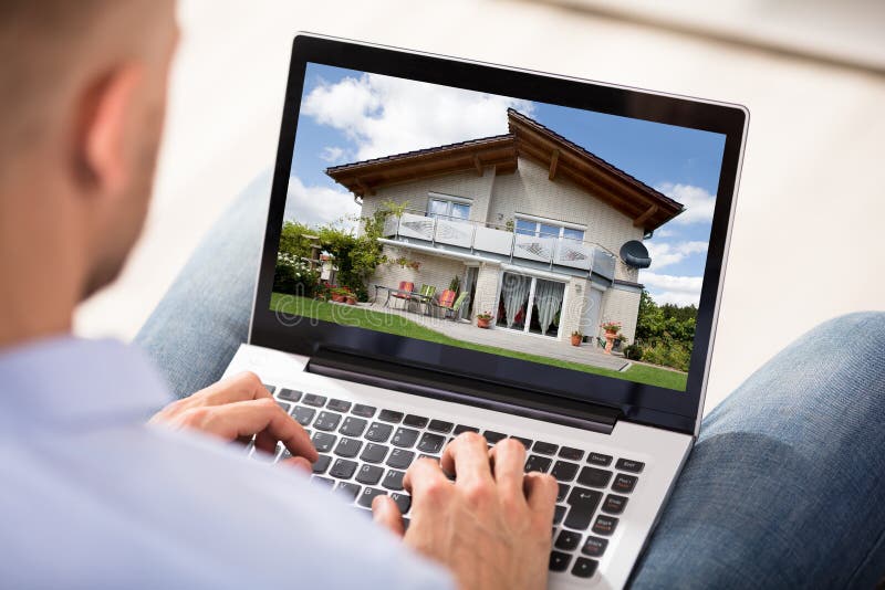 Man Looking at House Exterior on Laptop Stock Image - Image of ...