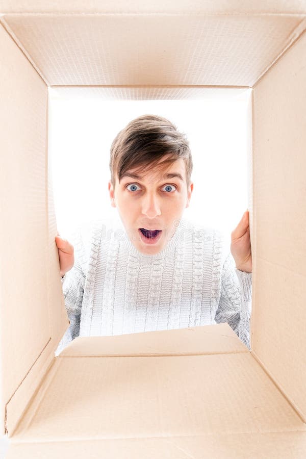 Man looking inside a box stock photo. Image of male - 235777112