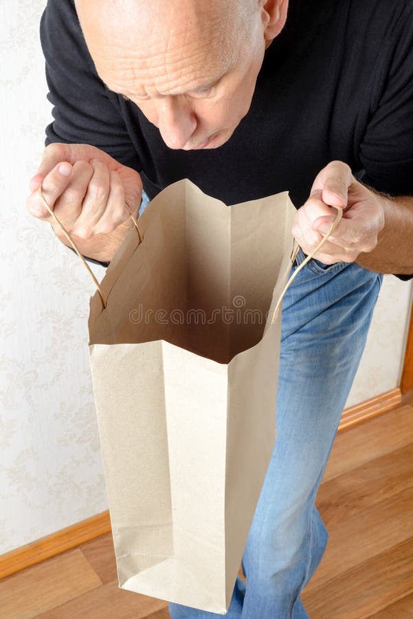 Man Looking Inside a Paper Bag Stock Photo - Image of looking, space ...