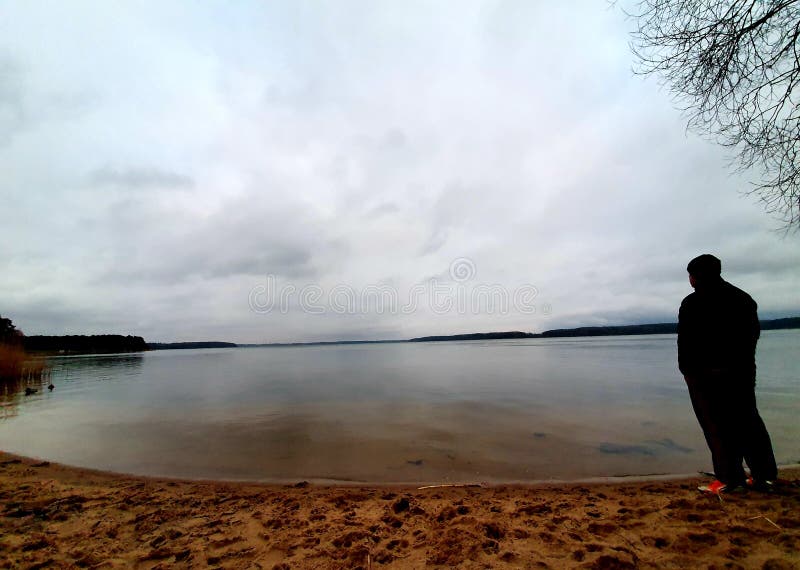 Man looking in the lake stock image. Image of sand, looking - 170512171