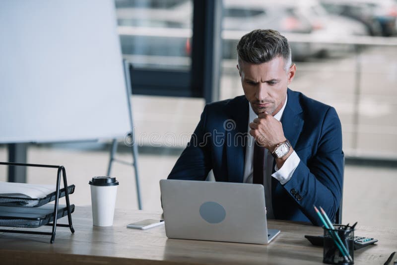 Man Looking at Laptop Near Smartphone on Table Stock Image - Image of ...