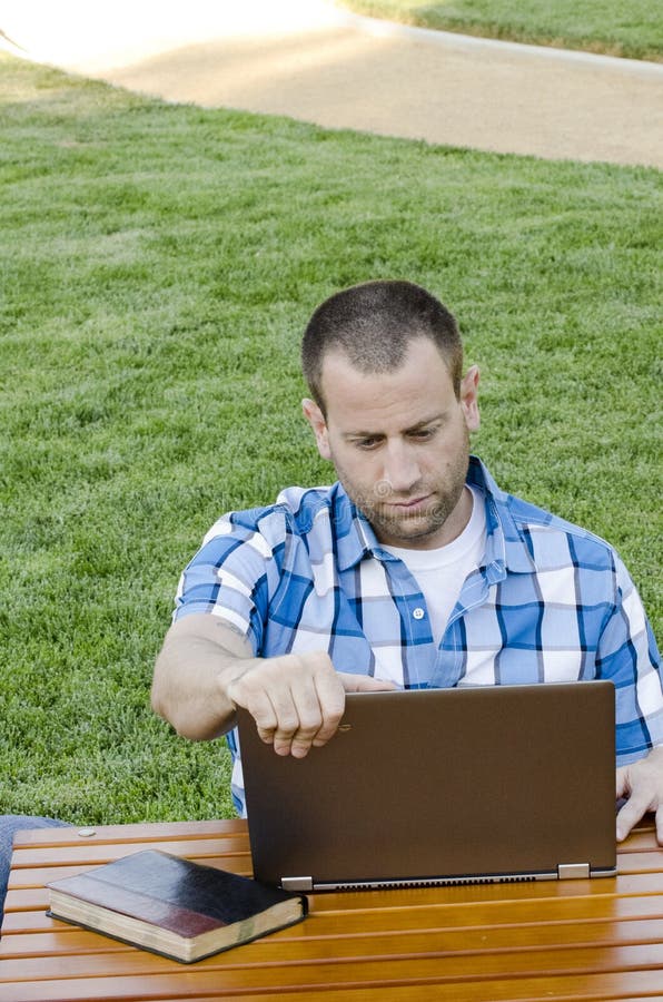 Man Looking at a Laptop Outdoors. Stock Image - Image of laptop ...
