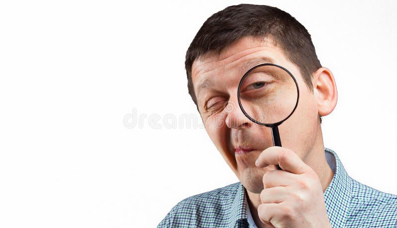 A Man Looking through a Magnifying Glass Stock Photo - Image of ...