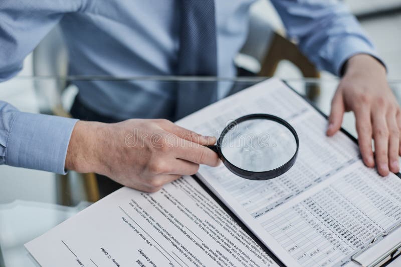 Businessman Looking through a Magnifying Glass To Documents Stock Image ...