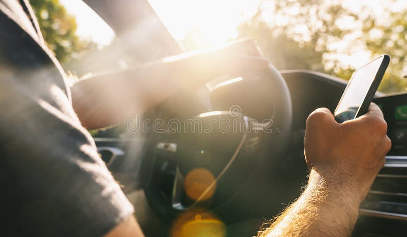 Man Looking at Mobile Phone while Driving a Car Stock Photo - Image of ...