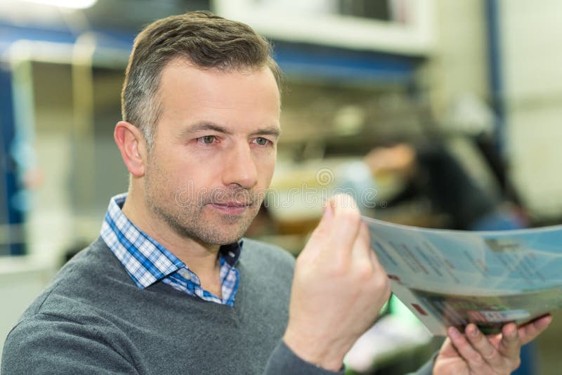 Man looking at paper stock photo. Image of male, creating - 249172444