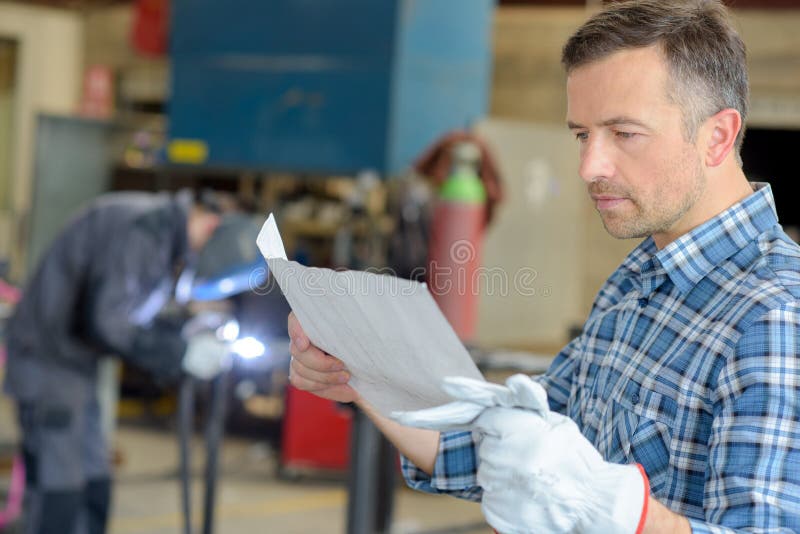 Man looking at paper stock image. Image of design, male - 84258845