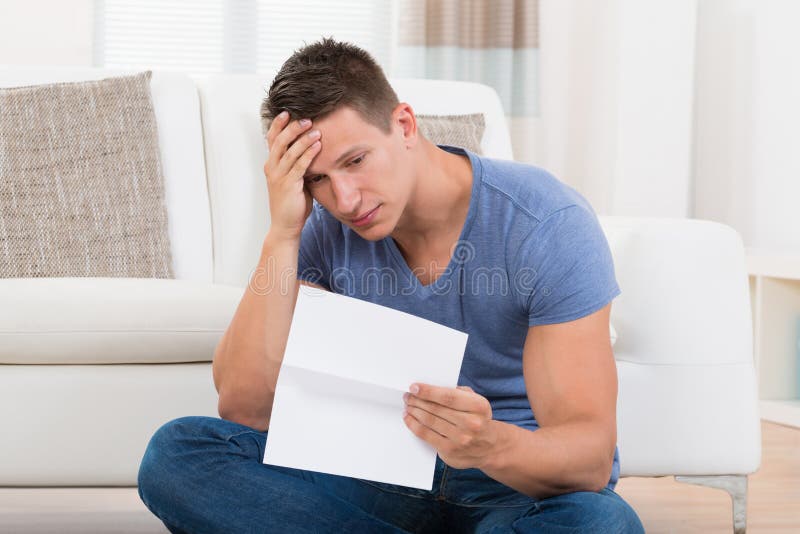 Man Looking at Paper stock image. Image of home, open - 58874057