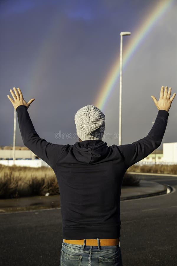Man looking at rainbow stock image. Image of geology - 204670157