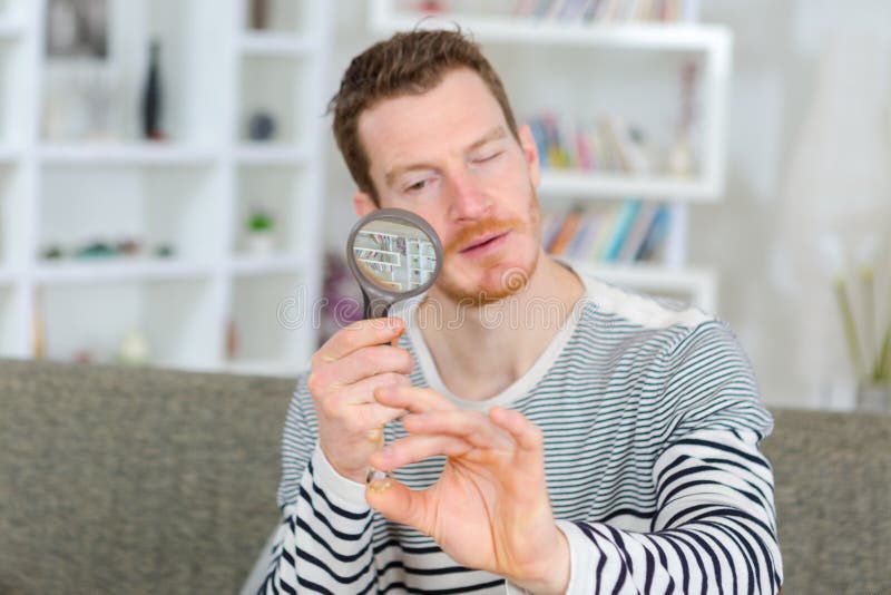 Man Looking at Ring through Magnifying Glass Stock Image - Image of ...