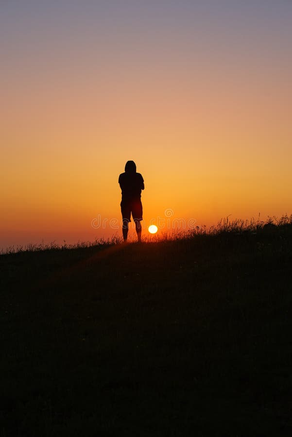 Man looking on rising sun stock photo. Image of orange - 152518792