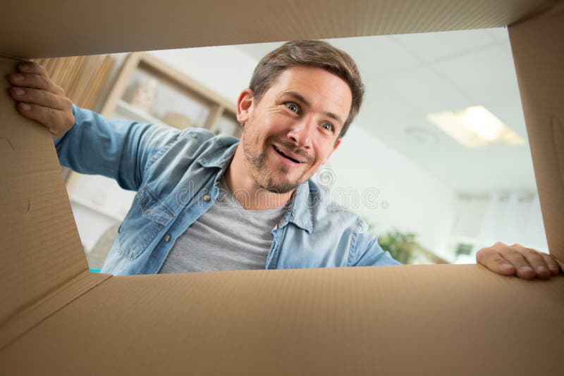 Man Looking at Something Inside Box Stock Image - Image of closeup ...