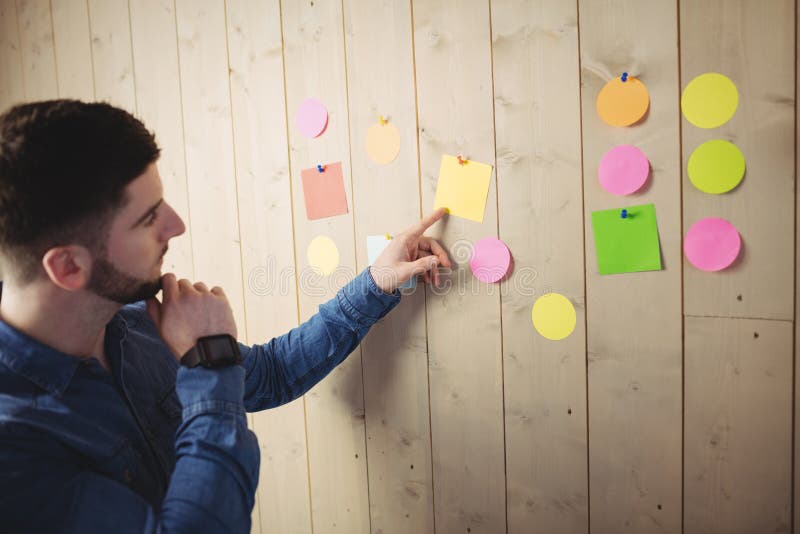 Man Looking at Sticky Notes Stock Image - Image of adult, indoors: 77700037