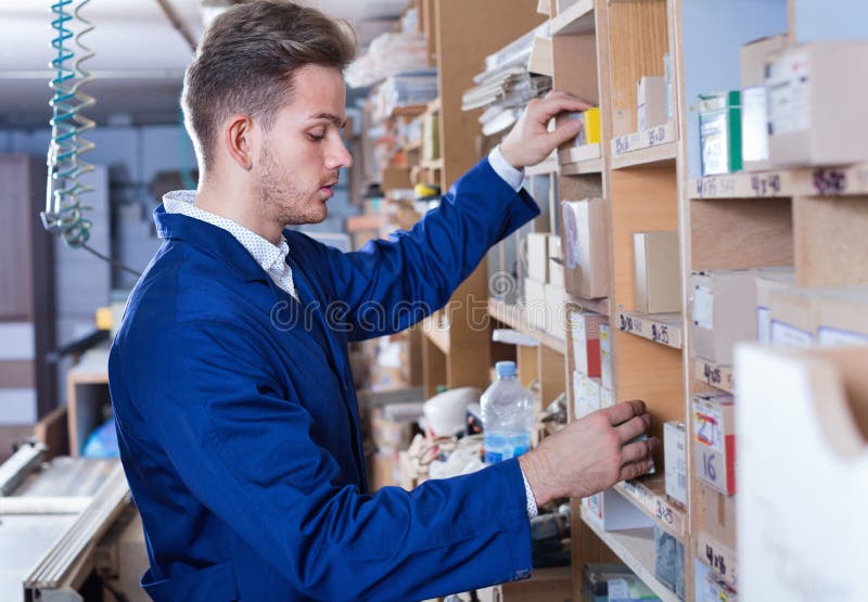 Man Looking through Stored Items at Workshop Stock Photo - Image of ...