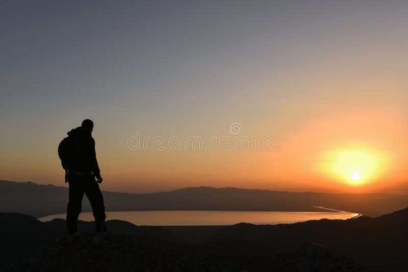 Man looking at sunrise stock photo. Image of hike, color - 118679254