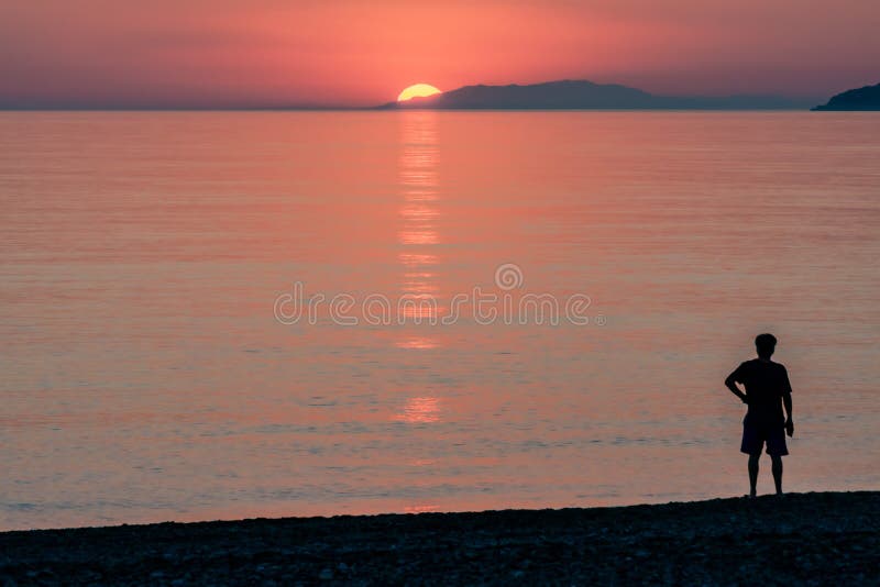 Man looking at the sunset stock image. Image of beach - 199036759
