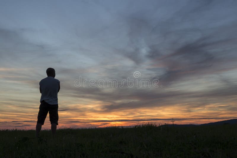 A Man Looking at the Sunset Stock Photo - Image of reddish, look: 76616834