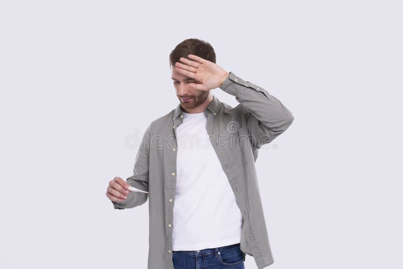 Man Looking at Thermometer Feeling Sick. Checking Themperature ...