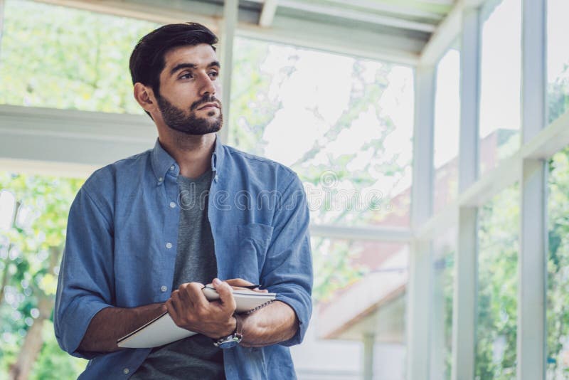 A Man Thinking and Writing His Idea at Note Book while Working at Home ...
