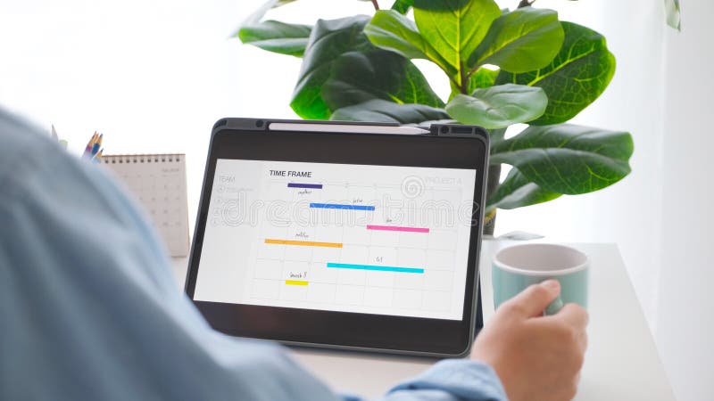 Man Looking at Time Frame Planner on Digital Tablet Screen for Mobile ...