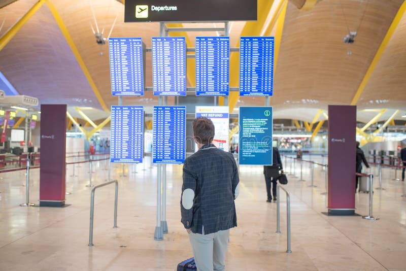 Man Looking at the Timetable Information Panel in the Airport Wi Stock ...
