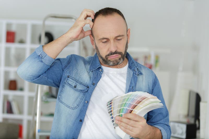 Man Looking To Color Paint Palette at Home Office Stock Image - Image ...