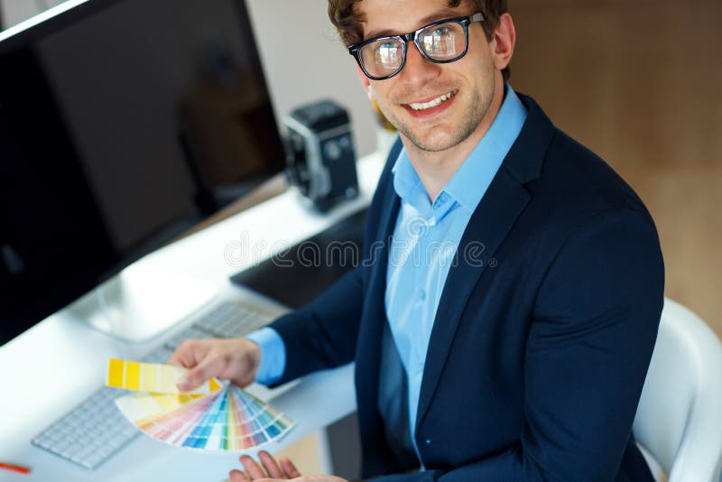 Man Looking To a Color Paint Palette at Home Office Stock Image - Image ...