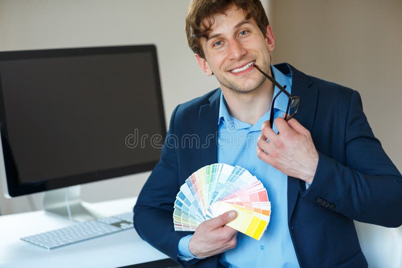 Man Looking To a Color Paint Palette at Home Office Stock Photo - Image ...