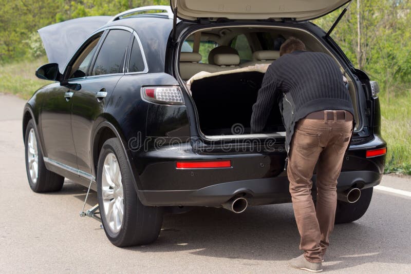 Man Looking for Tools in the Boot of His Car Stock Photo - Image of ...