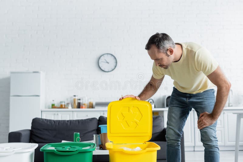 Man Looking at Trash Can with Stock Photo - Image of adult, kitchen ...
