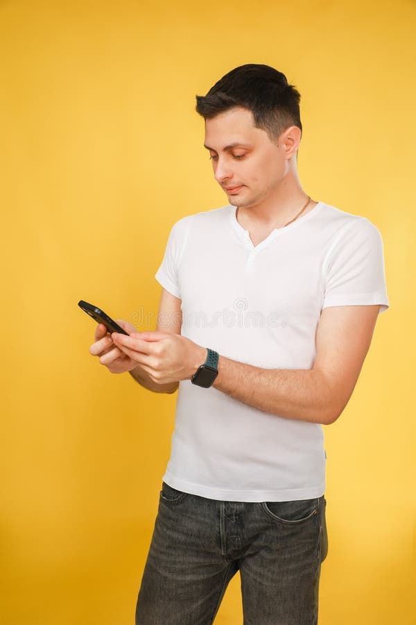 Man Looking at Watch and Phone on Yellow Stock Image - Image of ...
