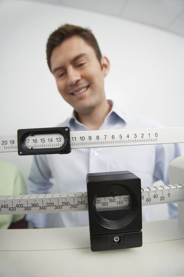 Happy Man Measuring Weight on Weighing Scale Stock Image - Image of ...