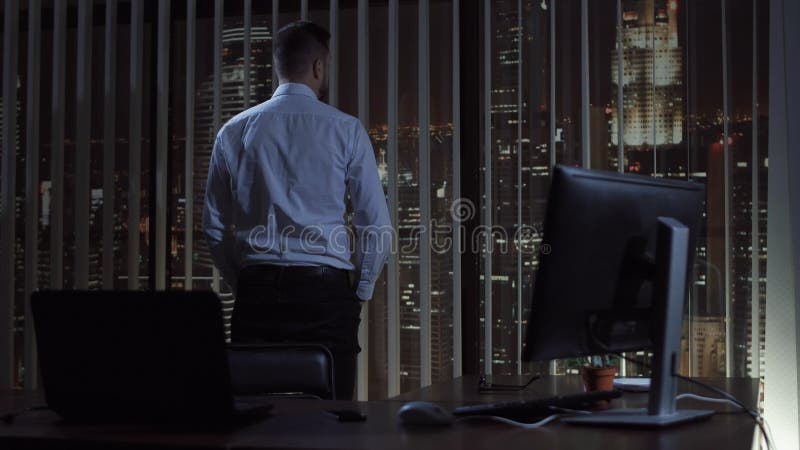 Man Looking in Window at Night Stock Image - Image of manager, person ...