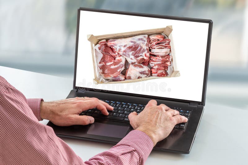 Man Lookint on Laptop Screen Meat Cuts in a Store Butcher Display Case ...