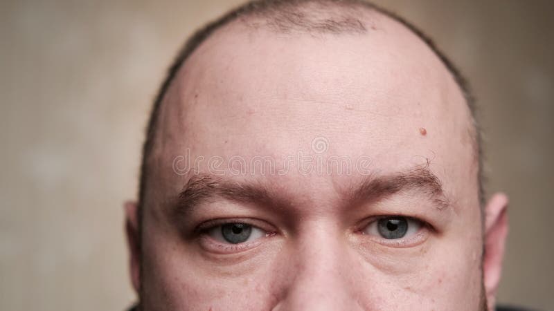 A Man Looks into the Camera Close-up. Upper Half of the Face Stock ...