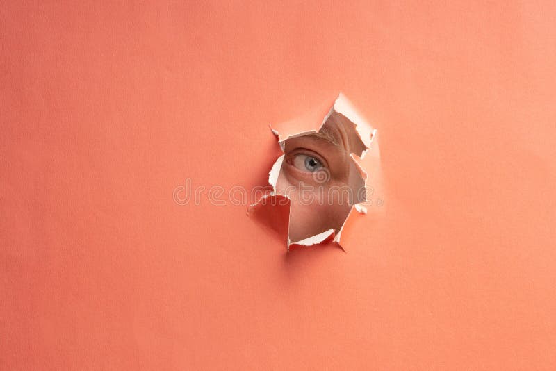 A Man Looks through a Cut Hole in the Paper. Observer through Paper ...