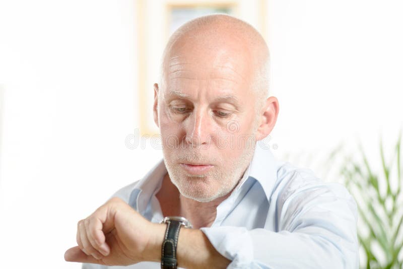 A man looks at his watch stock photo. Image of looking - 55316494