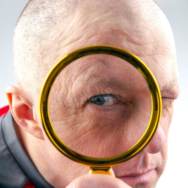 Man Looks through a Magnifying Glass Stock Photo - Image of search ...