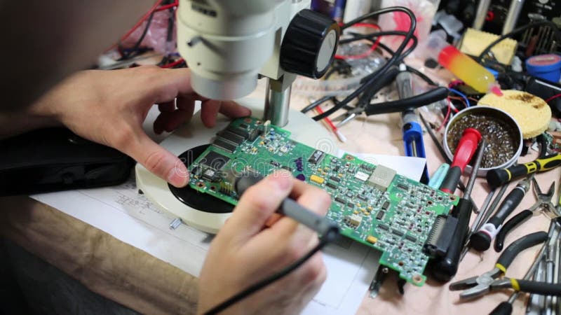 Man Looks at Motherboard through Microscope and Stock Footage - Video ...