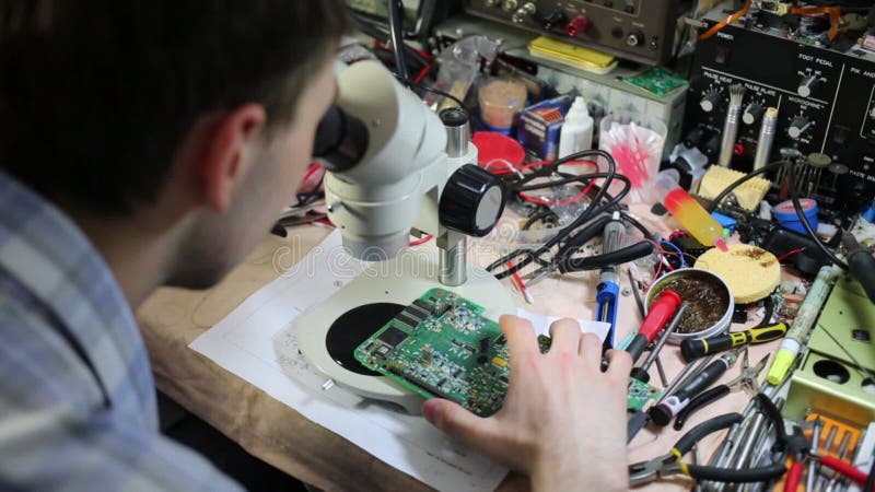 Man Looks at Motherboard through Microscope among Stock Video - Video ...