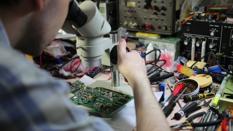 Man Looks at Motherboard through Microscope among Stock Video - Video ...